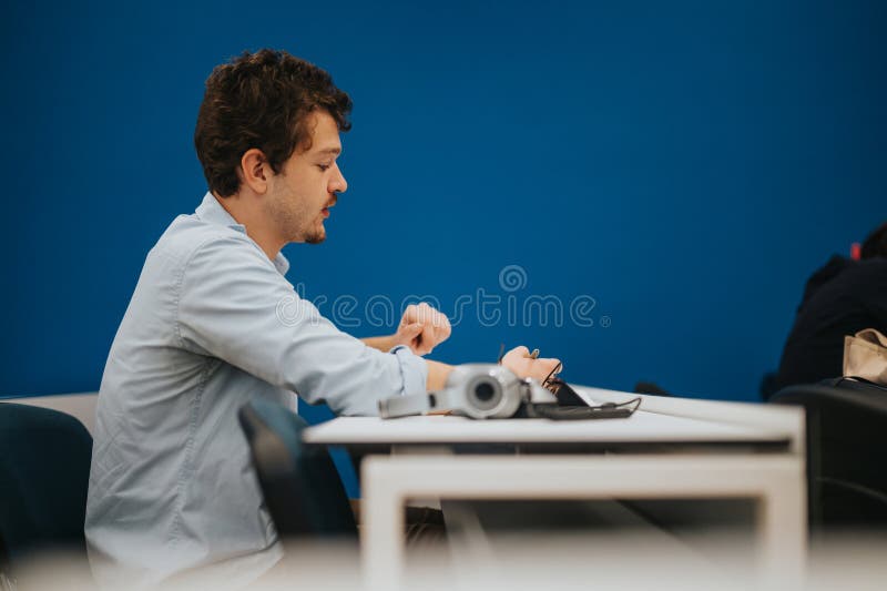 Student Working on Assignment with Concentration in Classroom Setting ...