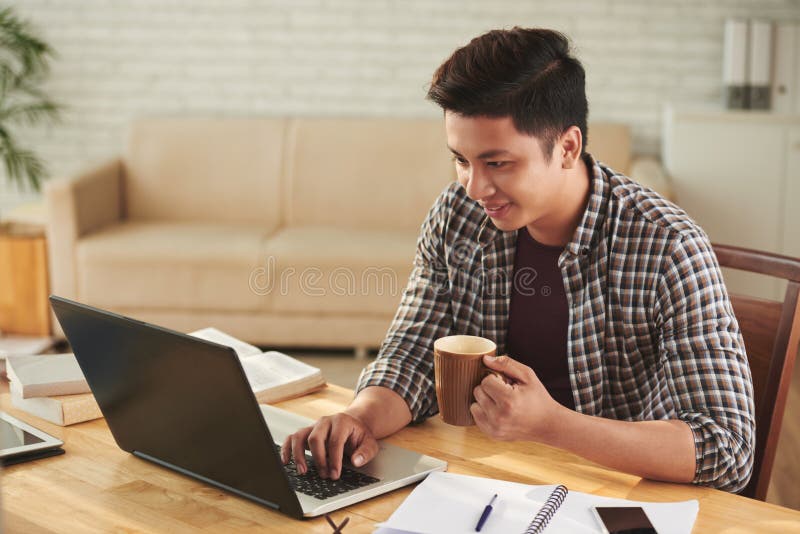 Student working on laptop stock image. Image of home - 92297821