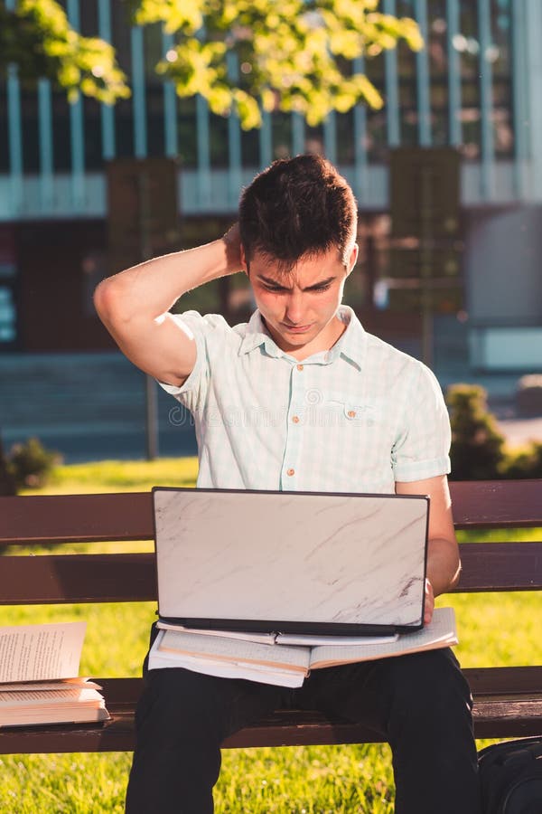 Student Working on Laptop Sitting on a Bench in the Park Stock Image ...