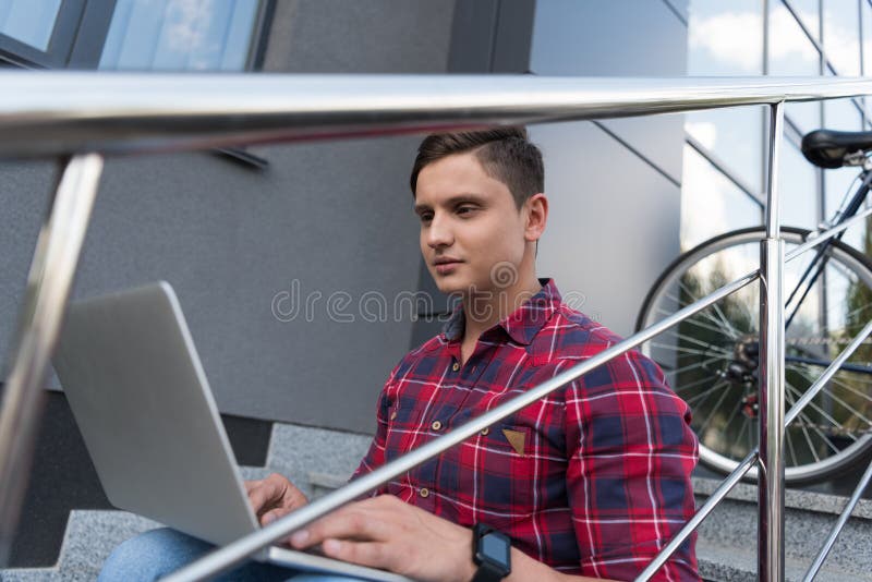 Student Working on Laptop while Sitting on Stairs at the Street Stock ...