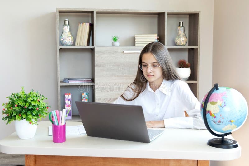 A Student Works on a Laptop. Concentrated Female Student Working on Her ...