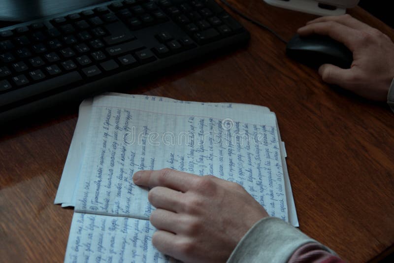A Student Works with a Notebook and a Computer on the Desktop Stock ...