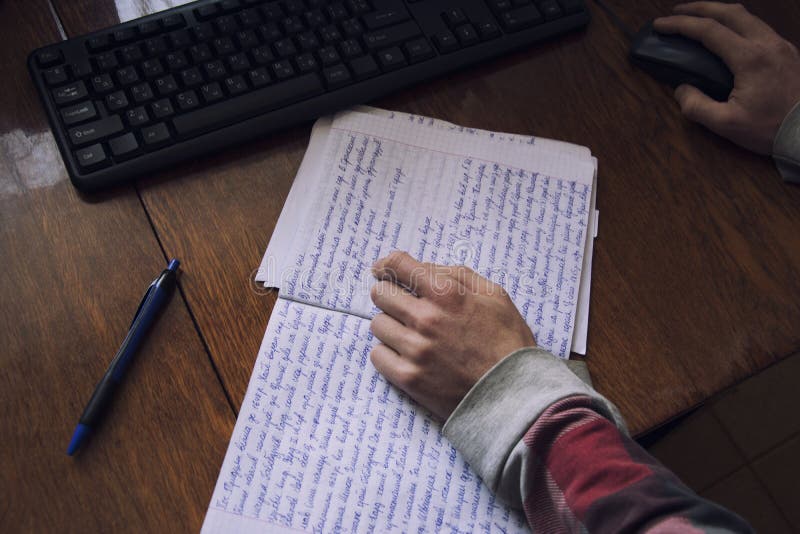 A Student Works with a Notebook and a Computer on the Desktop Stock ...