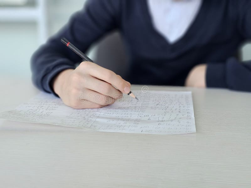 A Student Writes Notes in Class, Focusing on a Piece of Paper Stock ...