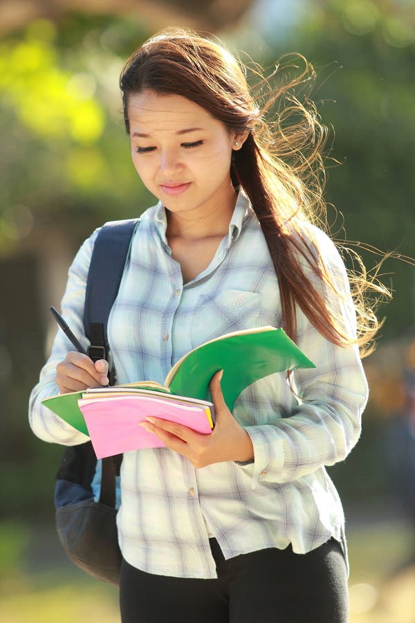 Student Writing on the Books Stock Photo - Image of model, bright: 42746982