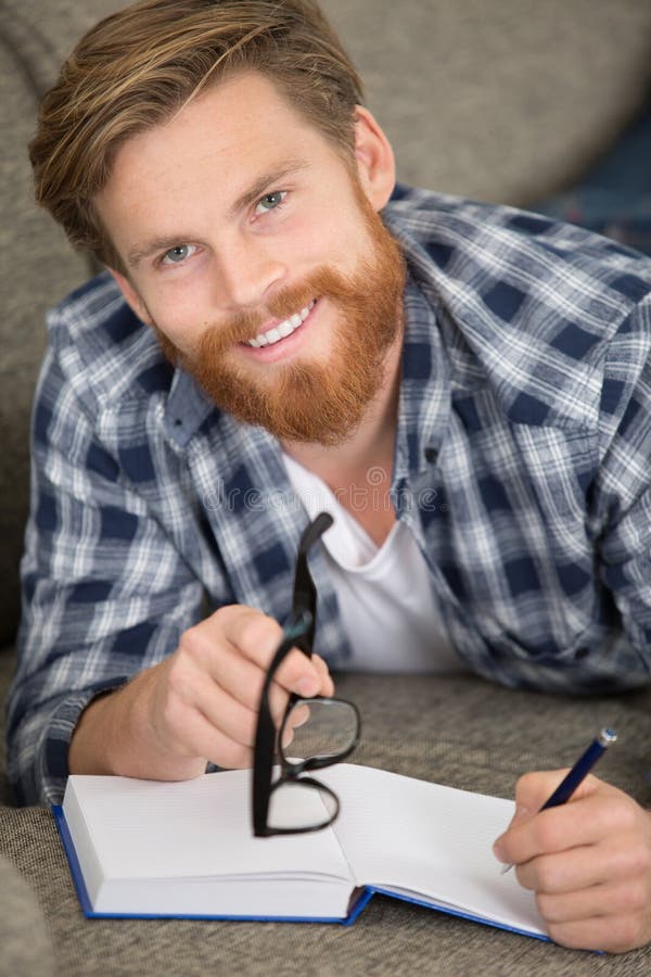 Student Writing Down Note on Sofa Stock Image - Image of relaxation ...