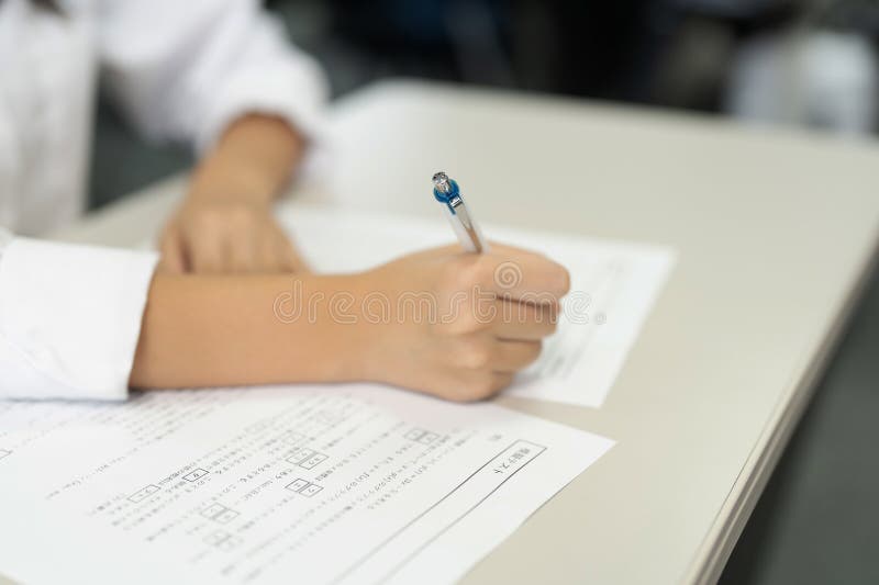 Student Writing on Exam Paper Stock Image - Image of uniform, school ...