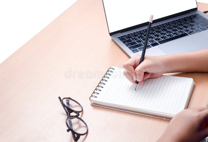 Student Writing Homework on Blank Notebook with Laptop on Desk Stock ...