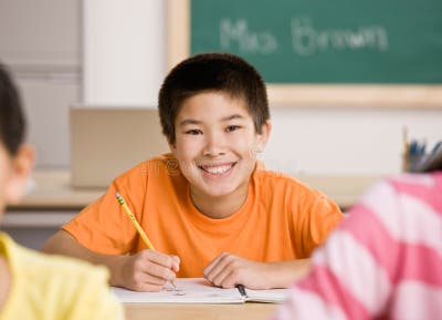 Student Writing in Notebook in School Classroom Stock Image - Image of ...