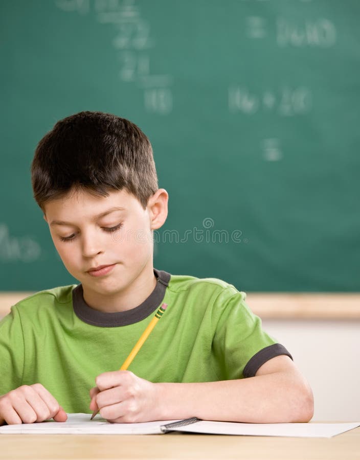 Student Writing in Notebook in School Classroom Stock Image - Image of ...