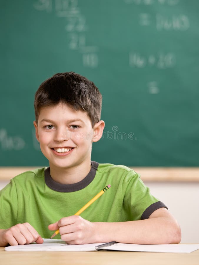 Student Writing in Notebook in School Classroom Stock Photo - Image of ...