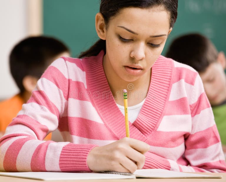 Student Writing in Notebook in School Classroom Stock Image - Image of ...