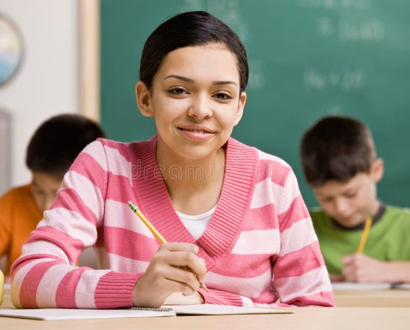 Student Writing in Notebook in School Classroom Stock Image - Image of ...