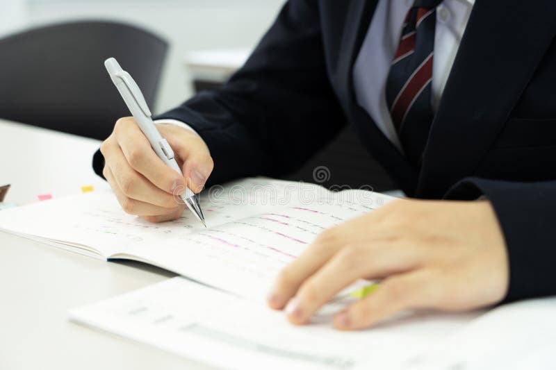 Student Writing Notes in the Book Stock Image - Image of hands, blazer ...