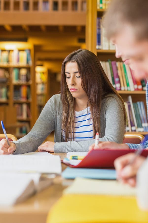 Student Writing Notes at Library Desk Stock Image - Image of caucasian ...
