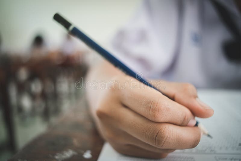 Student Writing Pen in Hand Doing Exams Answer Sheets Exercises in ...