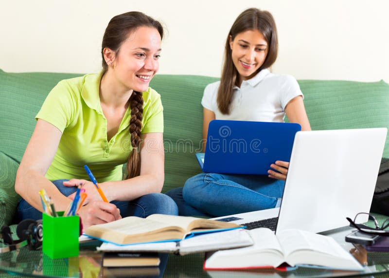 Studenti Con I Computer Portatili Che Fanno Compito Fotografia Stock ...