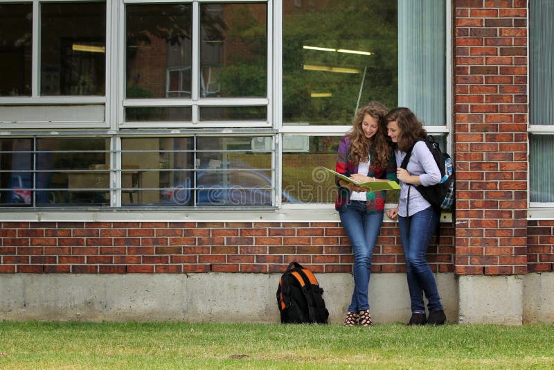 Students against a wall stock image. Image of building - 26162739