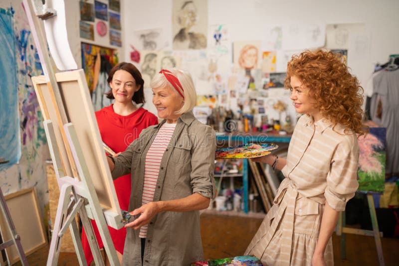 Students and Art Teacher Smiling while Painting and Talking Stock Photo ...