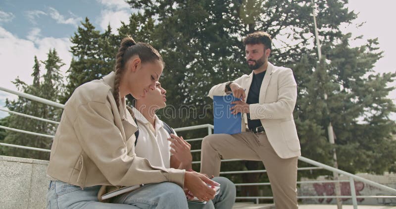 Students Receiving Guidance from Professor after Outdoor Class ...