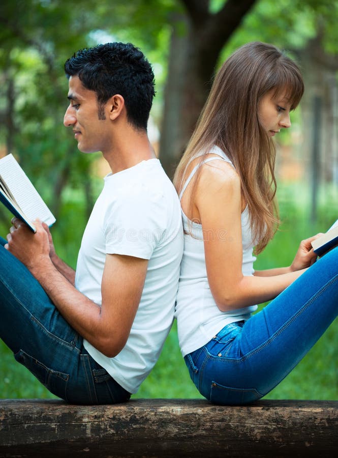 Students Back To Back Reading a Book Outdoors Stock Photo - Image of ...