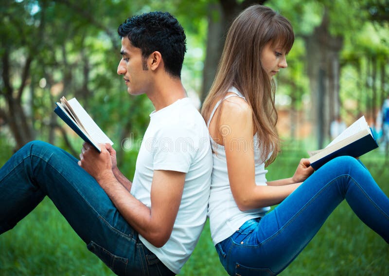 Students Back To Back Reading a Book Outdoors Stock Image - Image of ...