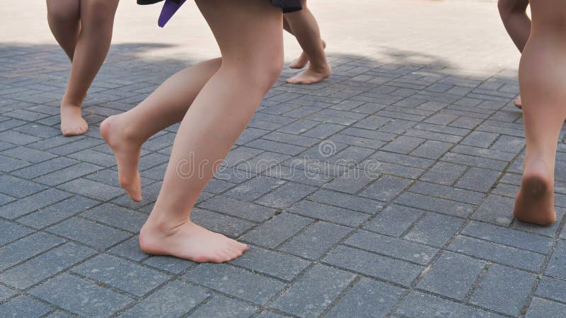 Students Celebrating End of School Year, Walking Barefoot on Pavement ...