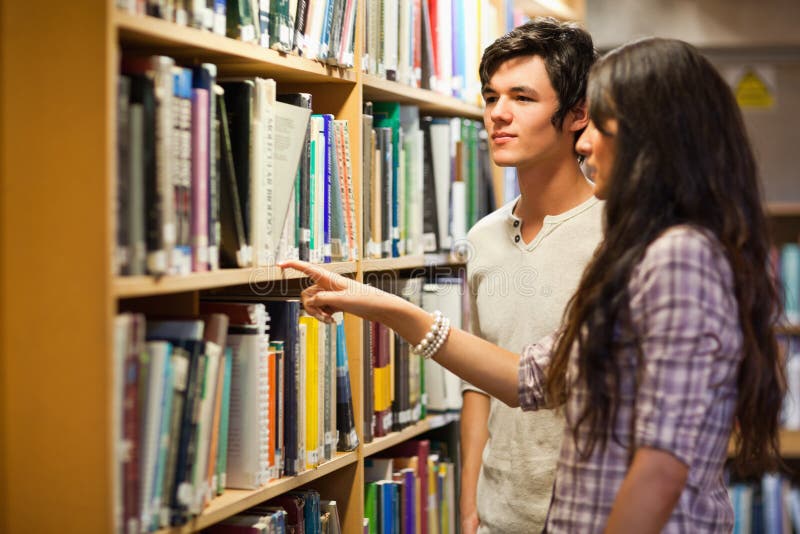 Students Choosing a Book on a Shelf Stock Photo - Image of intelligence ...