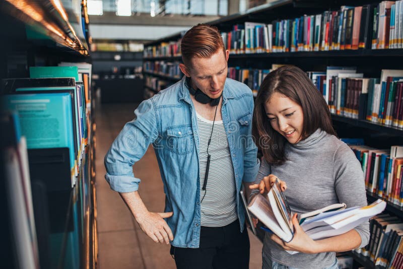 Students Choosing a Book in a Library Stock Image - Image of mixed ...