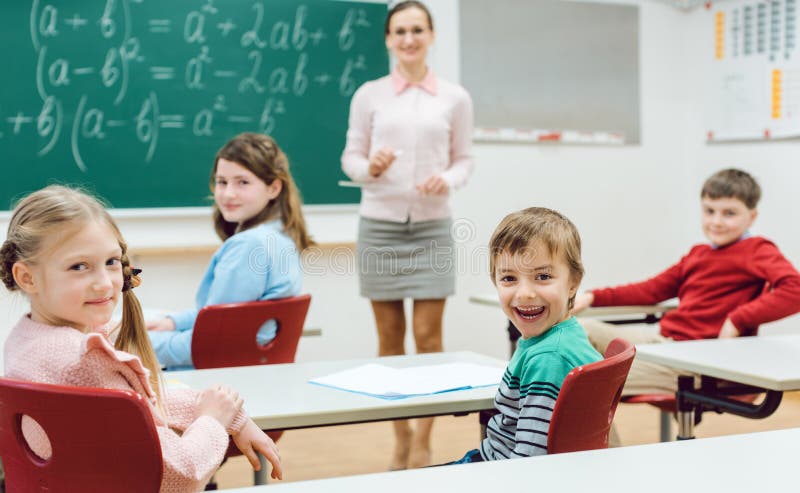 Students in Class Raising Hands To Answer a Question Stock Photo ...