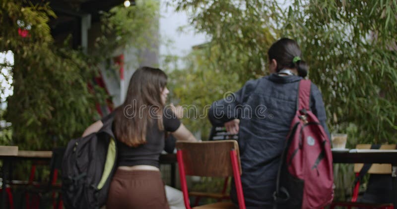 Students Studying Together at Outdoor Cafe: a Scene of Focused ...