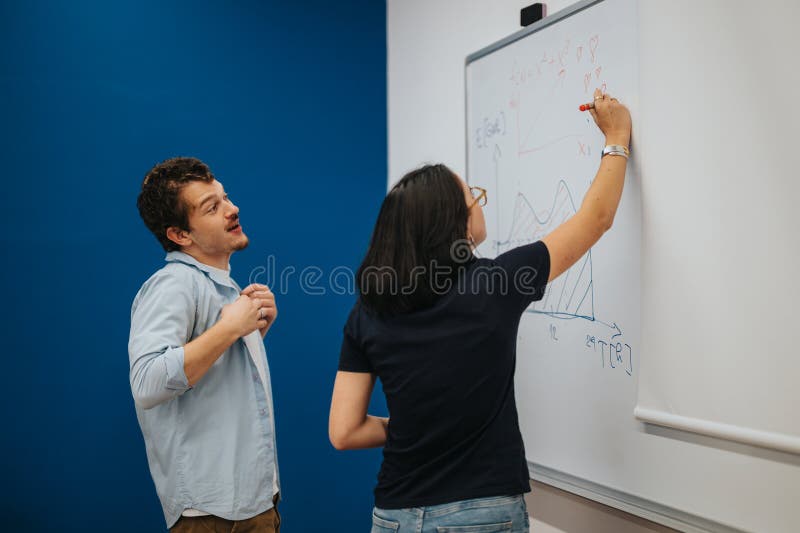 Students Collaborating on Mathematical Problem at School Classroom ...