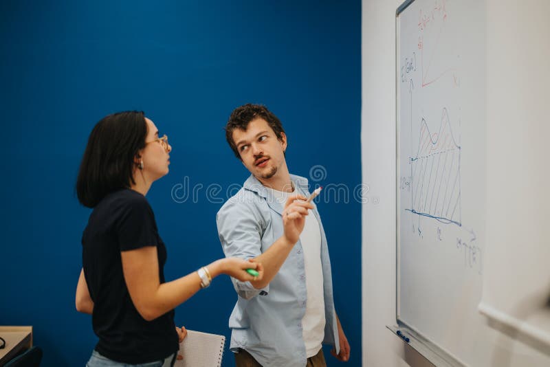 Students Collaborating on a Project at the Whiteboard in Classroom ...