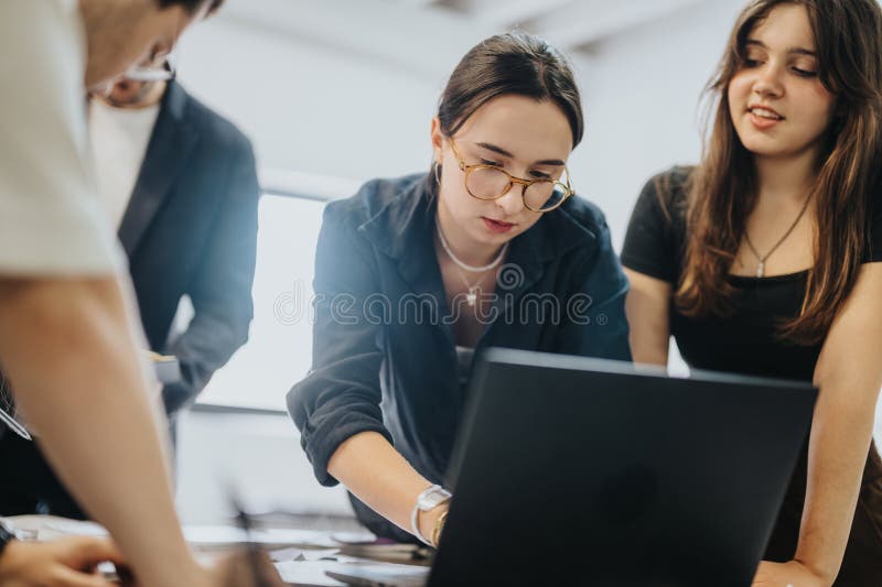 Students Collaborating on School Assignments Using a Laptop Stock Photo ...