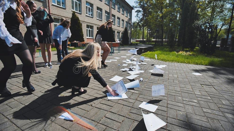Students Collect Papers that Have Been Scattered by the Wind. Stock ...