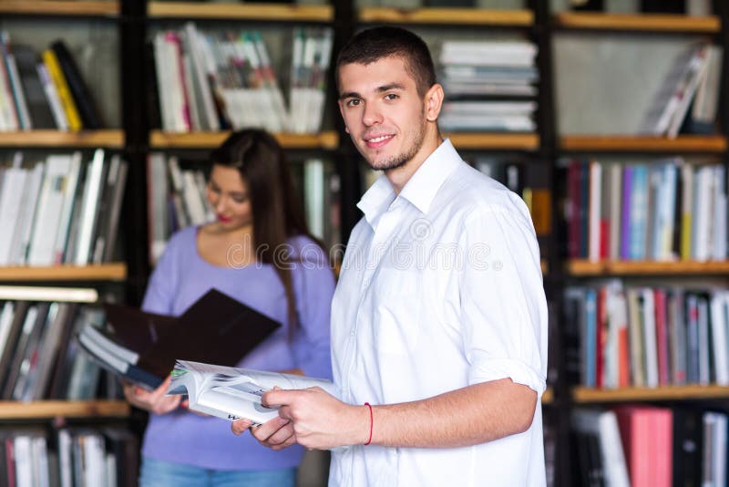 Students Communicate in a Library. Young Man and Woman Talking in the ...
