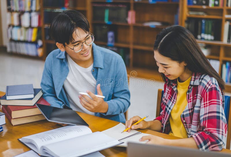 Students are Consulting Each Other Working on Laptops and Searching for ...