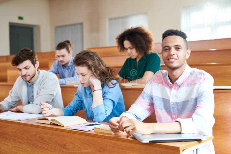 Students at desk stock photo. Image of school, college - 118091324