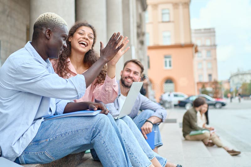 Students Enthusiastically Discussing Something on the Steps. Stock ...