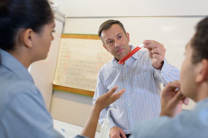 Students Discussing Chemistry Experiment in Science Class Stock Photo ...