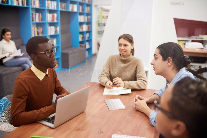 Students Discussing Project in College Library Stock Photo - Image of ...