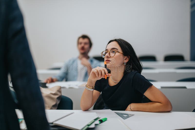 Students Engaged in Classroom Learning with Professor Assistance Stock ...