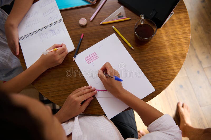 Students Engaging in Homework with Notebooks and Coffee Stock Image ...
