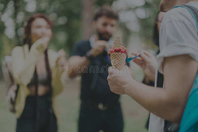 Students Enjoy an Ice Cream Break with Professor Outdoors Stock Photo ...