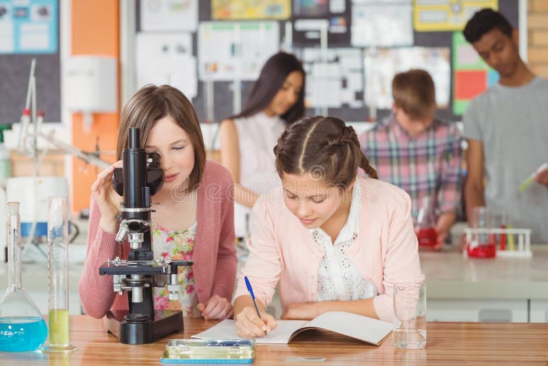 Students Experimenting on Microscope in Laboratory at School in ...