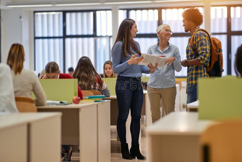Students Asking Female Professor for Help at an Informatics Lecture ...