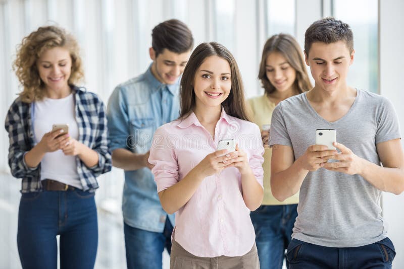 Students with gadgets stock image. Image of girl, phones - 56341609