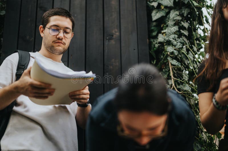 High School Students Collaborating on Homework Assignments Outdoors ...