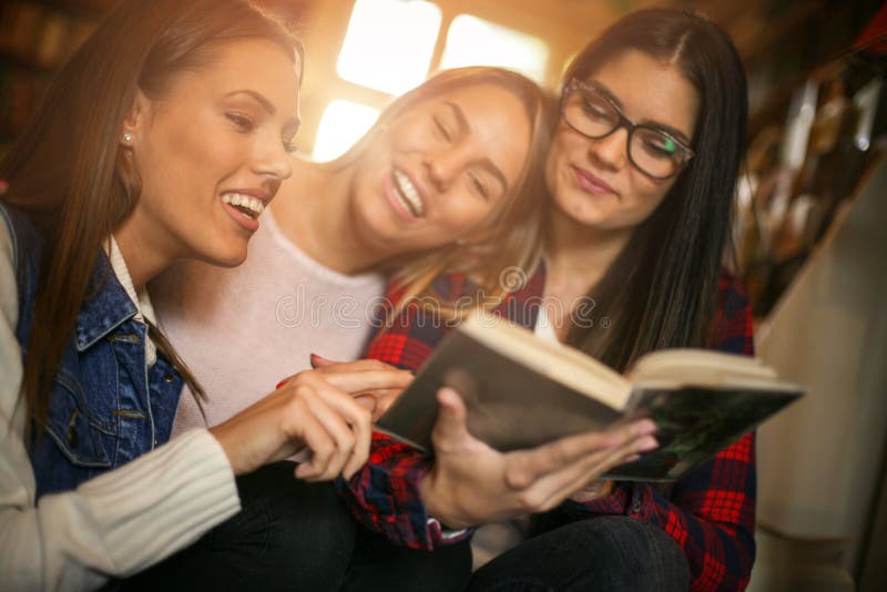 Students Girls in Library Reading Book and Having Conve Stock Photo ...