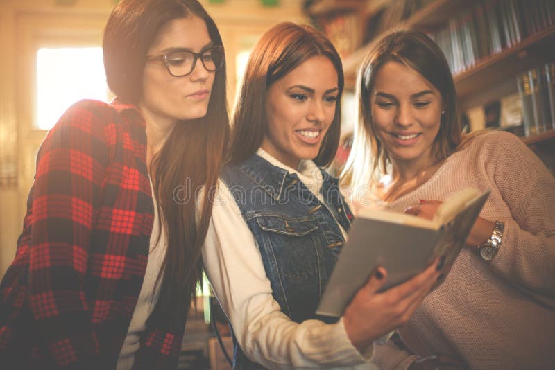 Students Girls in Library Reading Book and Having Conversa Stock Image ...